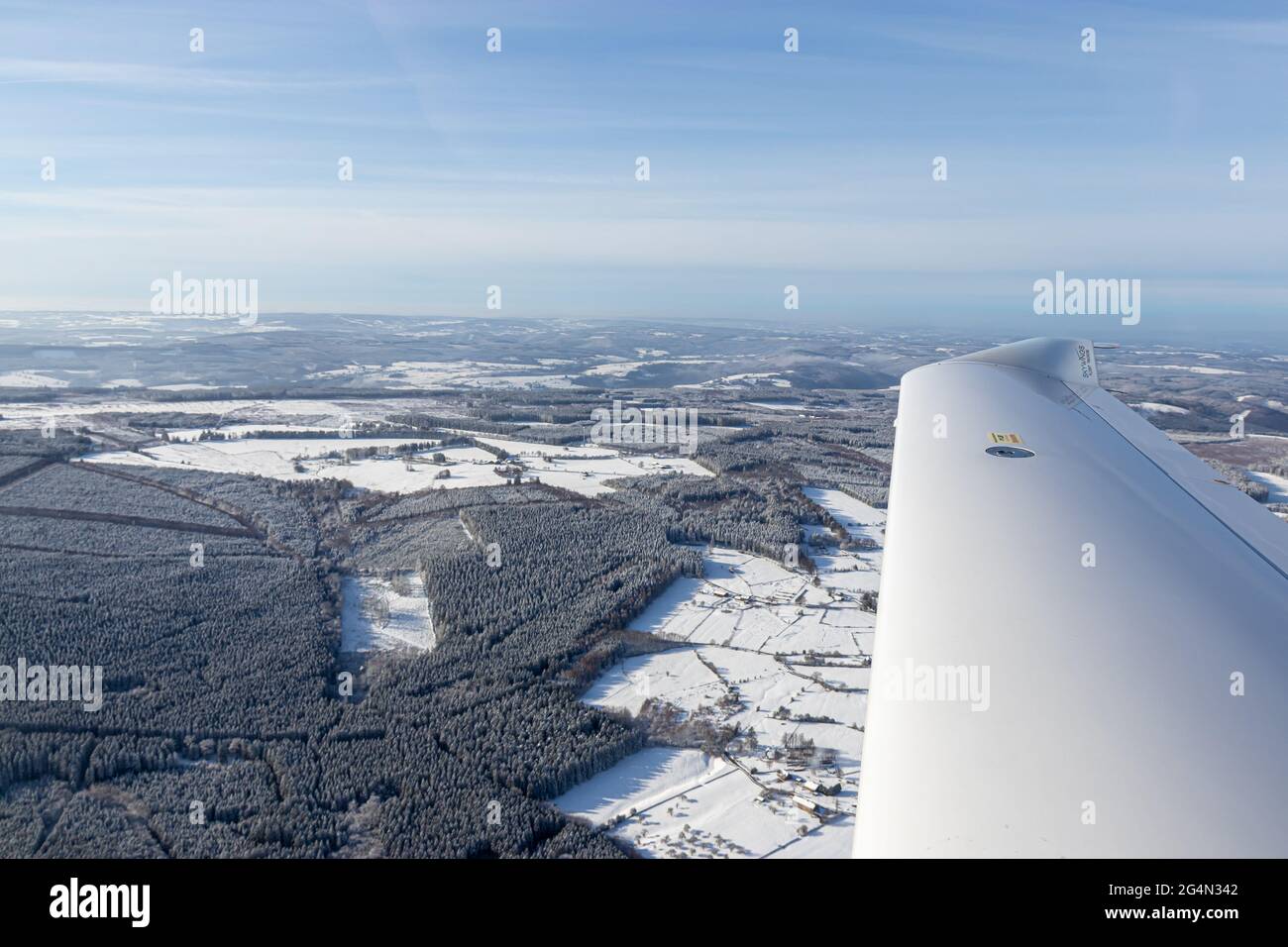 Aerial overview of the Belgian Ardennes during a winter flight with an ...