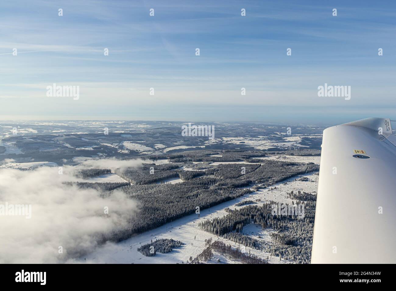 Aerial overview of the Belgian Ardennes during a winter flight with an ...