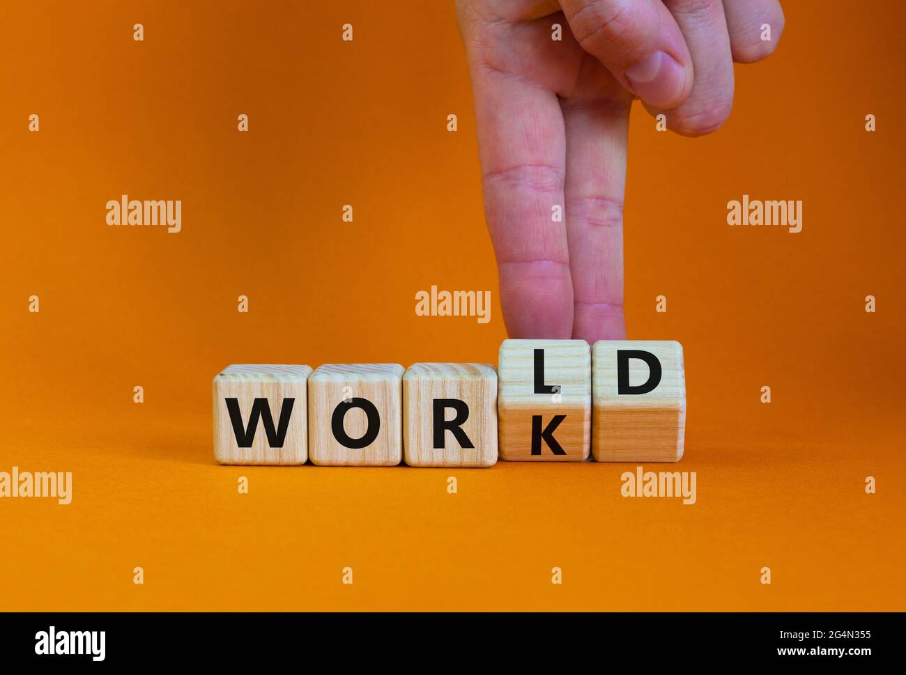 World and work symbol. Businessman turns wooden cubes and changes the ...