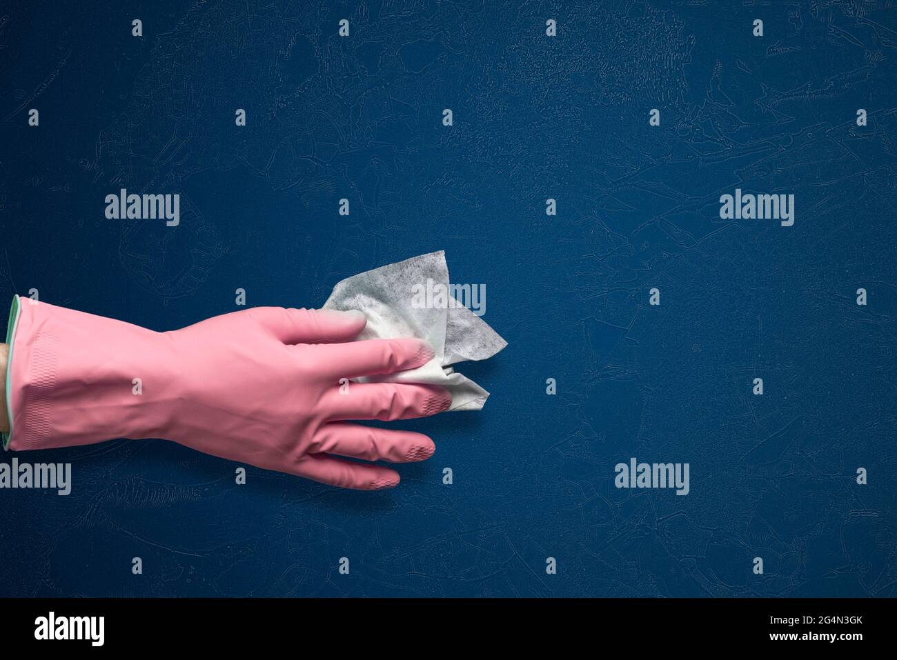 woman hand on latex glove holding a color rag isolated and wash a color ...