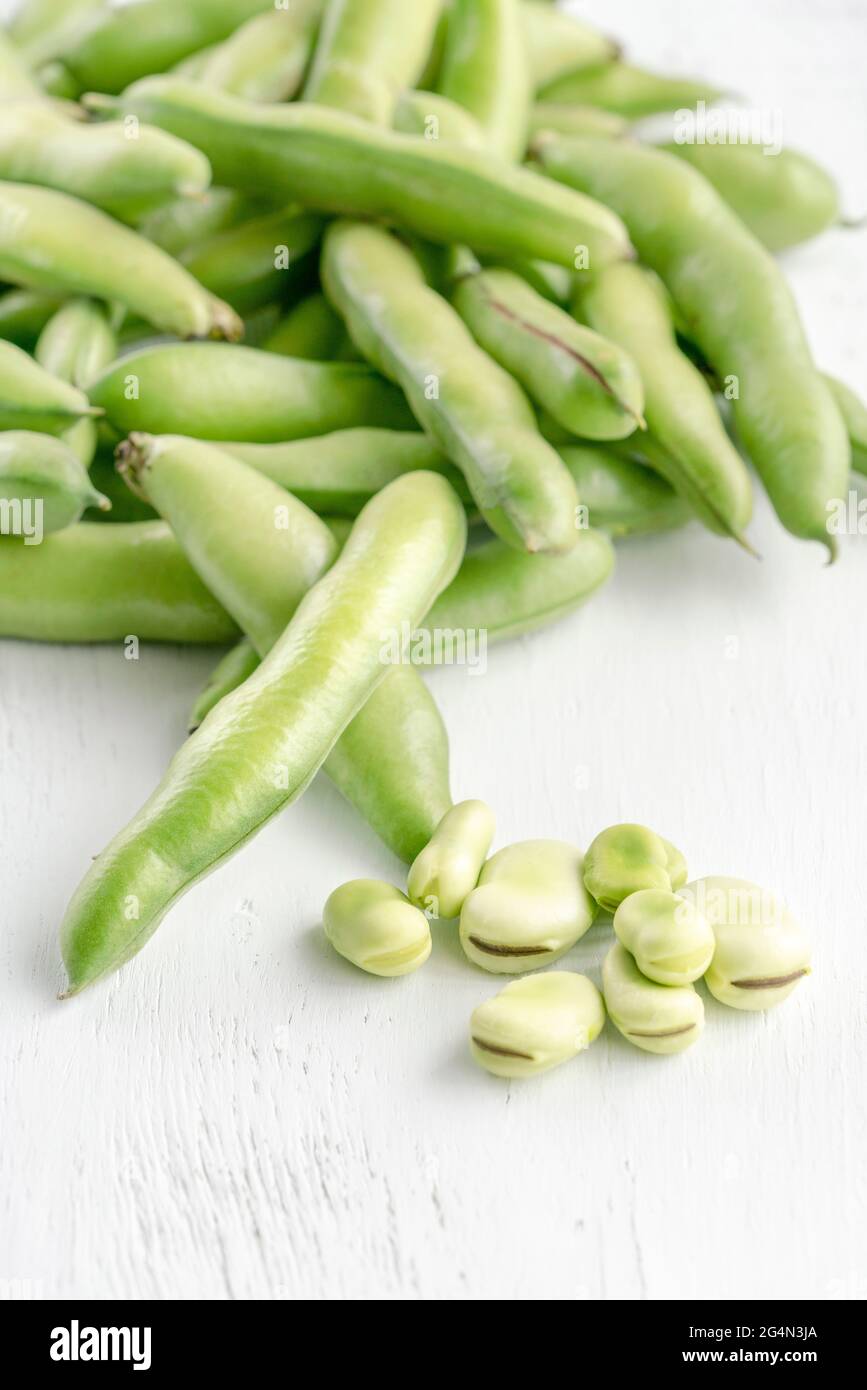 closeup fresh broad beans on the white wooden table Stock Photo - Alamy