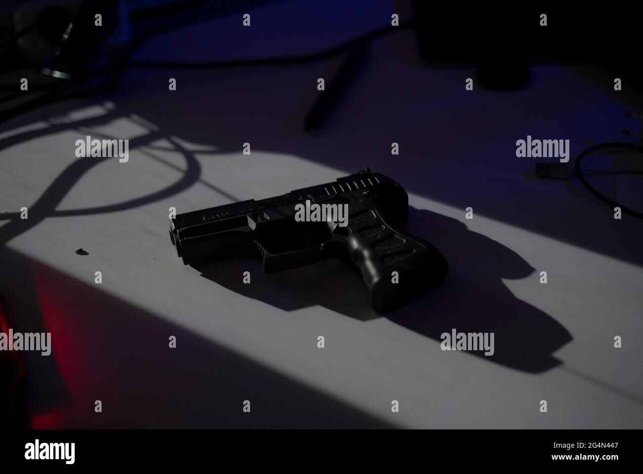 the black 9mm pistol gun on the table in dark room, plan to make a ...