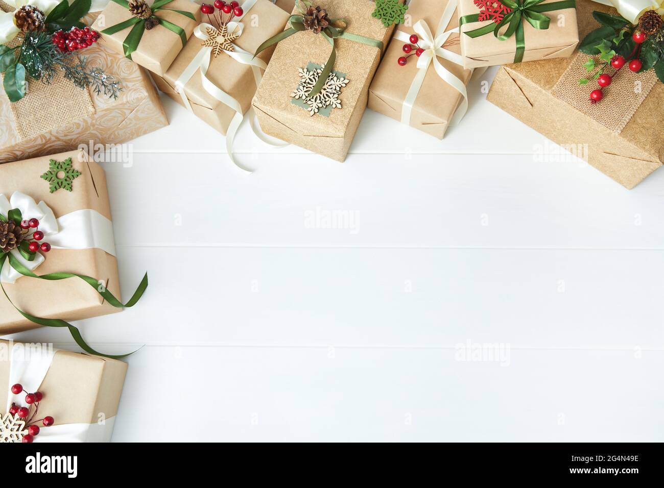 Border of gift boxes wrapped in kraft paper on white wood desk ...
