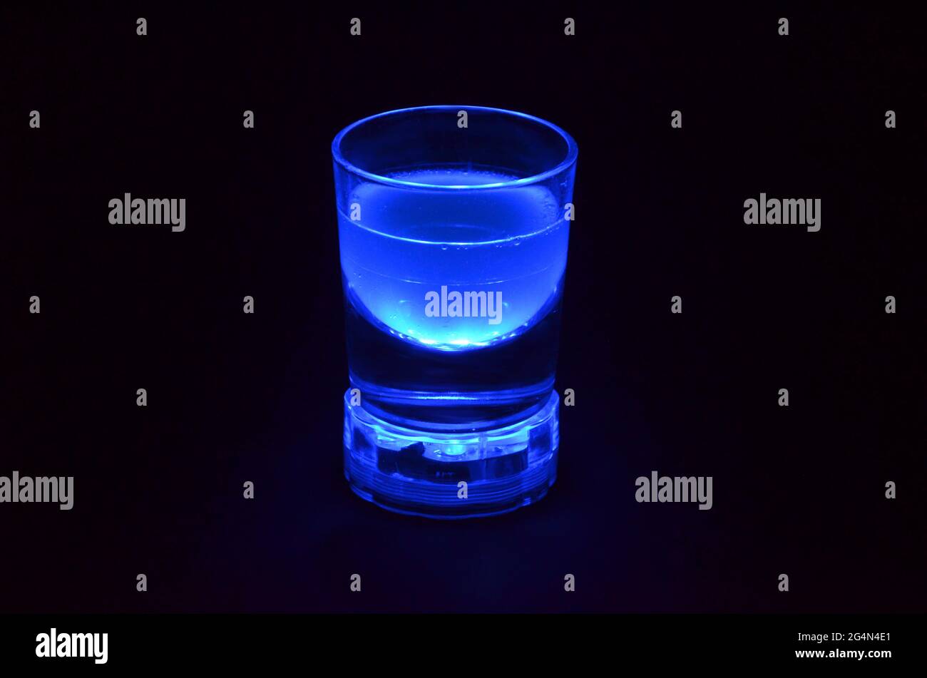 blue glowing drink in a glass, glowing glass on black background Stock ...