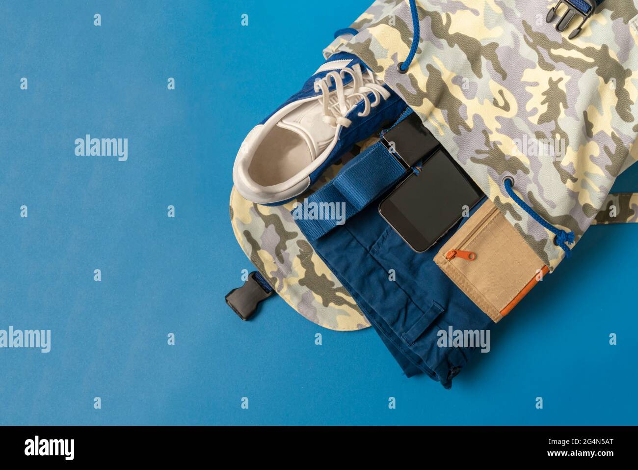 a view from above on casual simple backpack with things and clothes ...