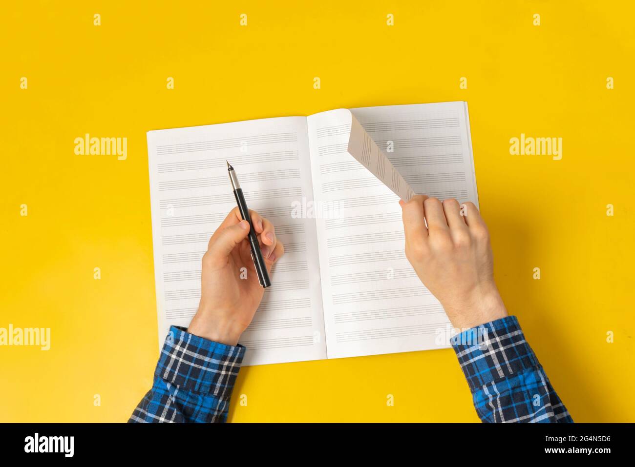 a view from above, person taking down the notes in notebook, empty ...