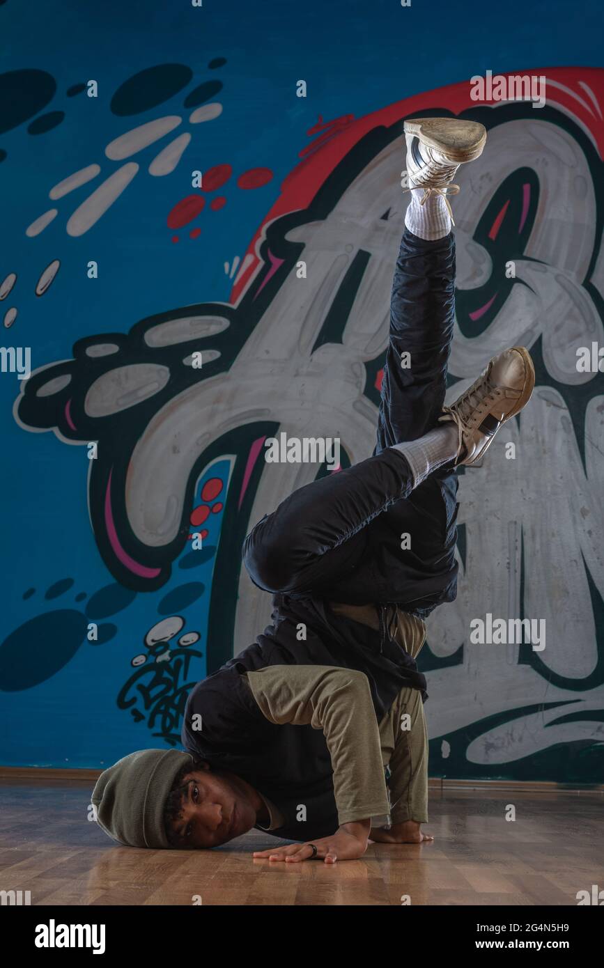 Modern rapper dancing in garage. Urban lifestyle, hip hop Stock Photo ...