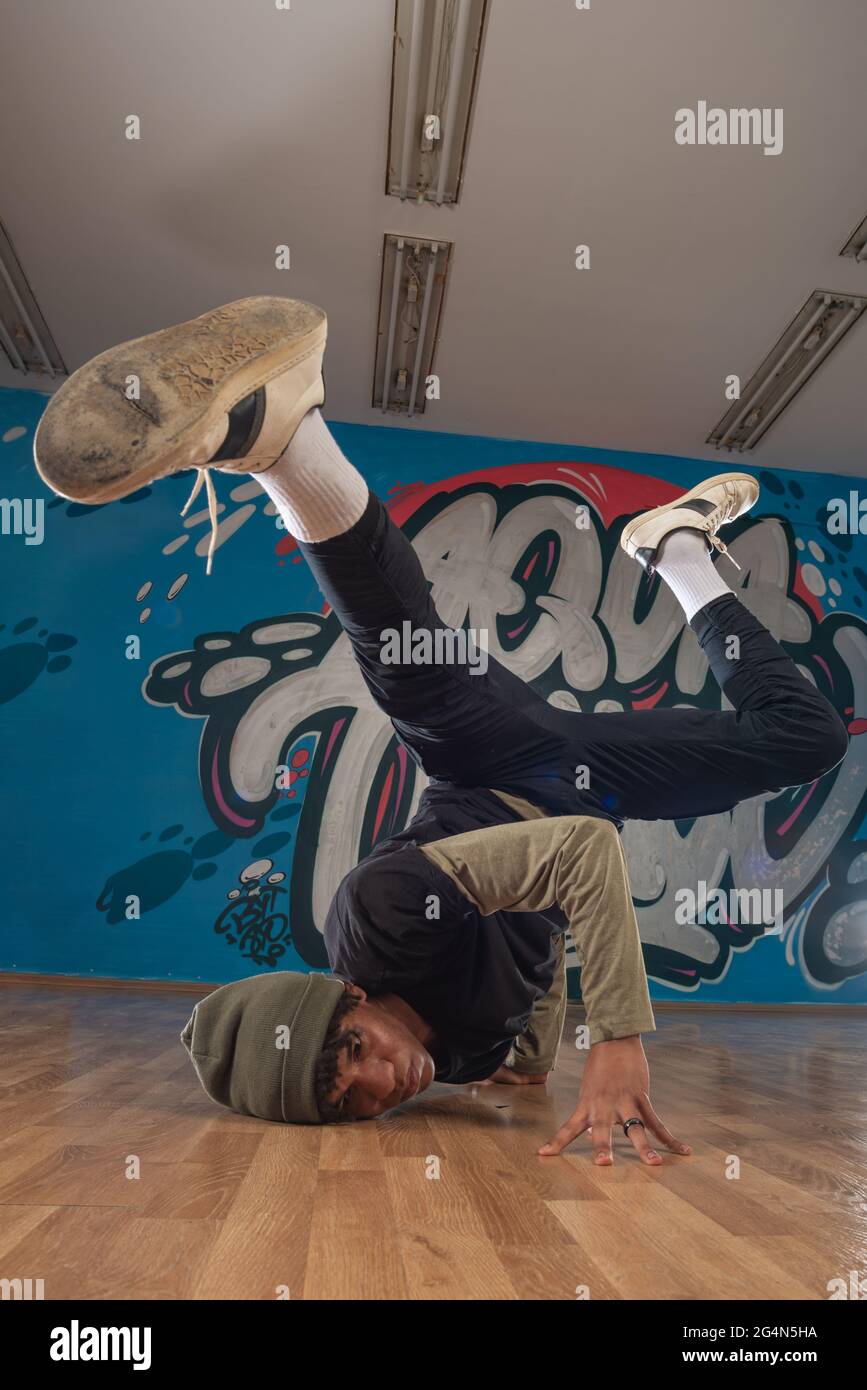 Modern rapper dancing in garage. Urban lifestyle, hip hop Stock Photo ...