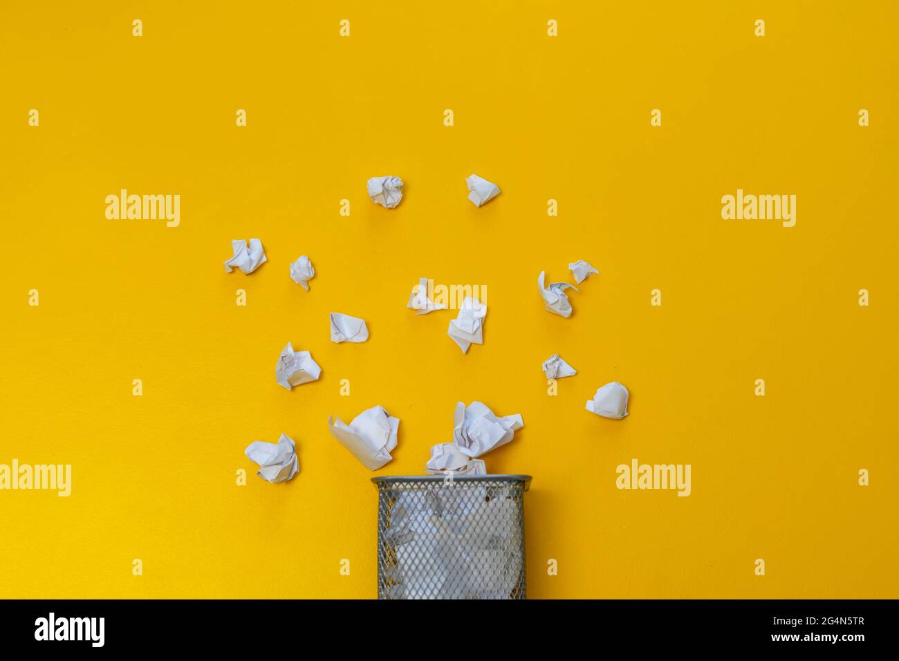 the bunch of crumpled paper balls in the metal rubish bin urn basket on ...