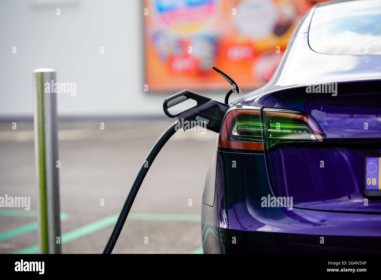 modern electric car being charged at public charging point Stock Photo ...