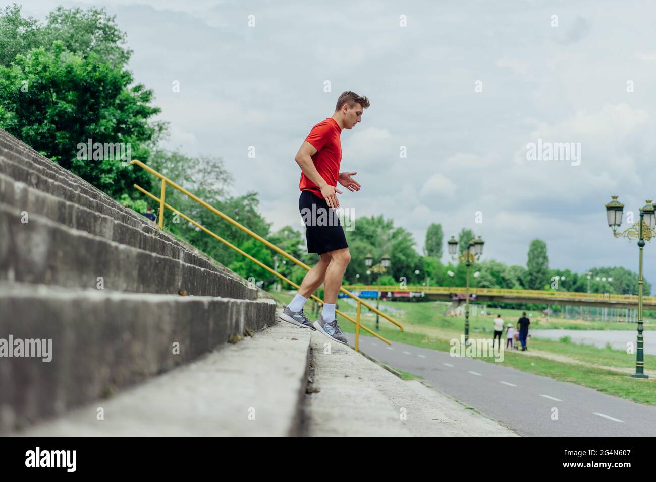 Fit male athlete performing stairs workout, running up climbing stairs ...