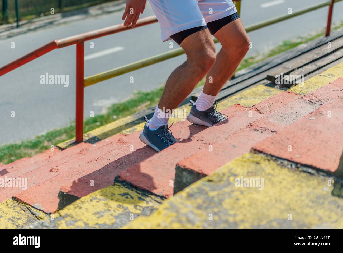 Closeup picture of athlete's feet with sneakers jumping on stairs in a ...