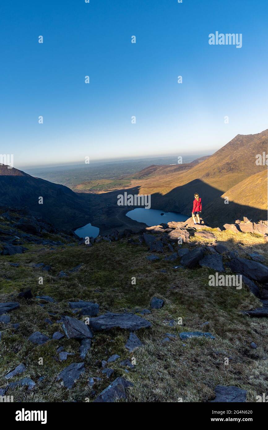 A happy woman on top of devils ladder with two lakes in the background ...