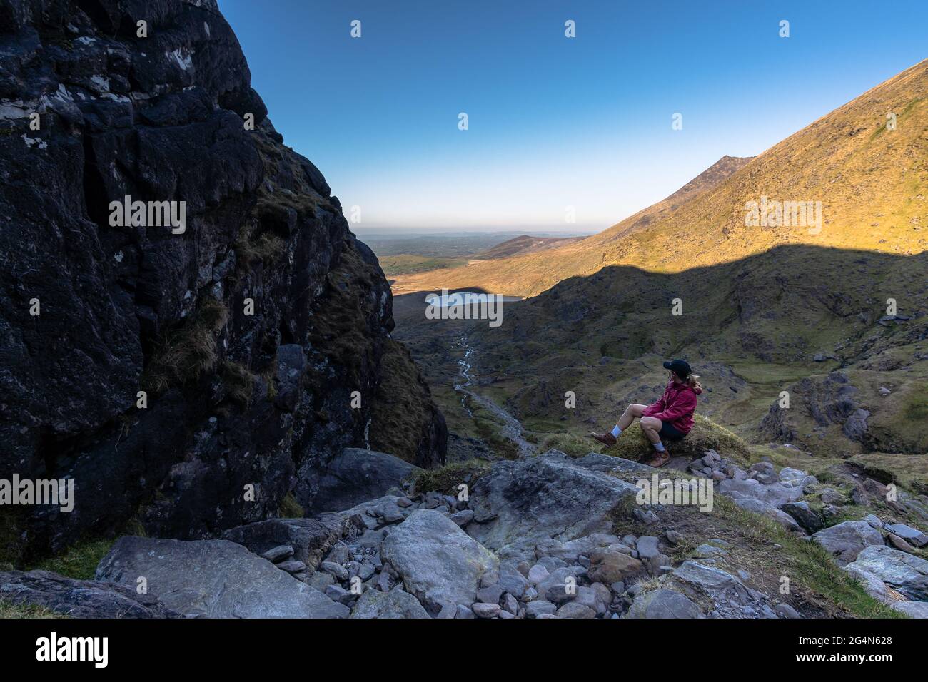 A happy woman on top of devils ladder with two lakes in the background ...