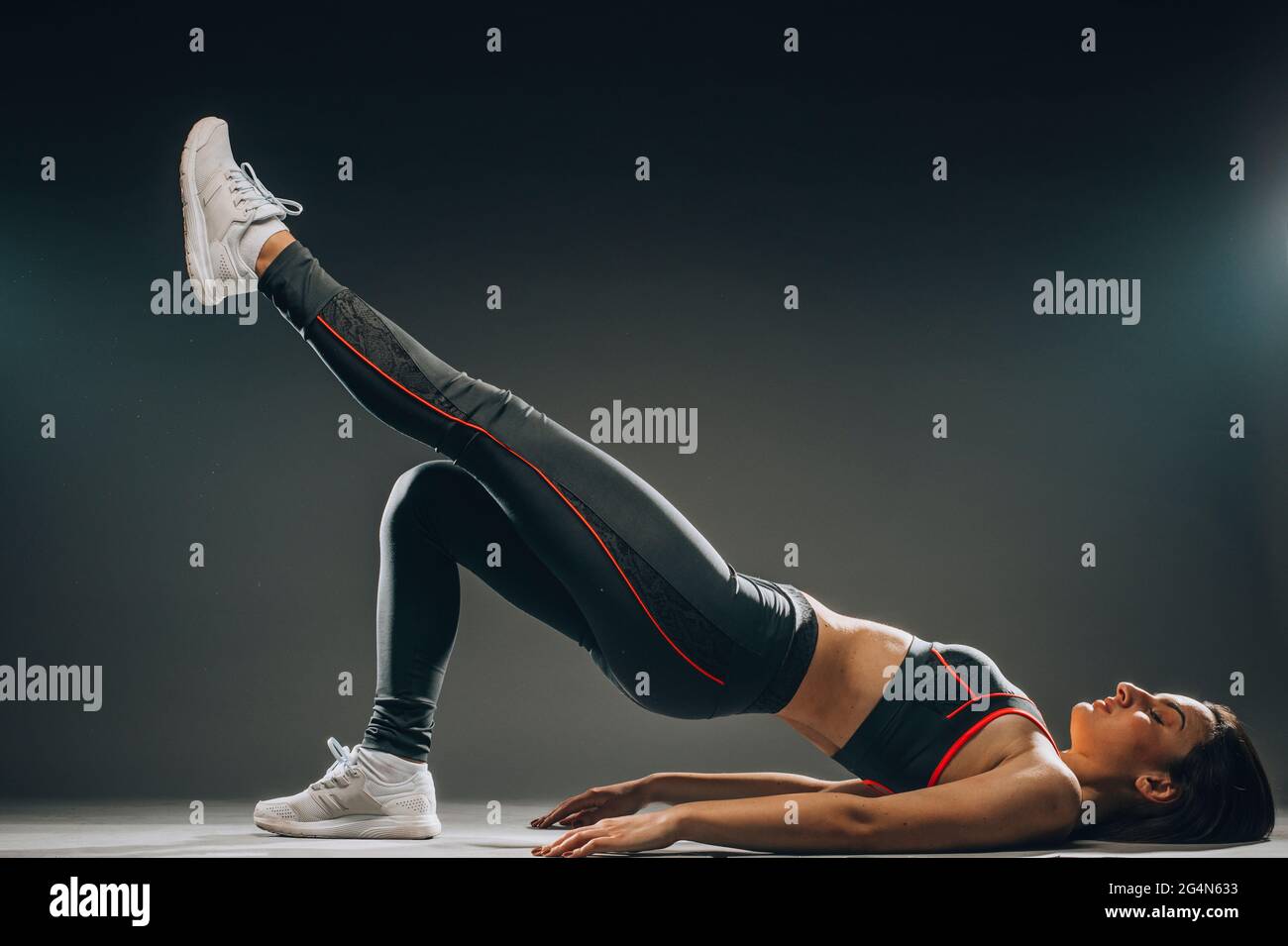 Working her core muscles. Full length of young beautiful woman in ...