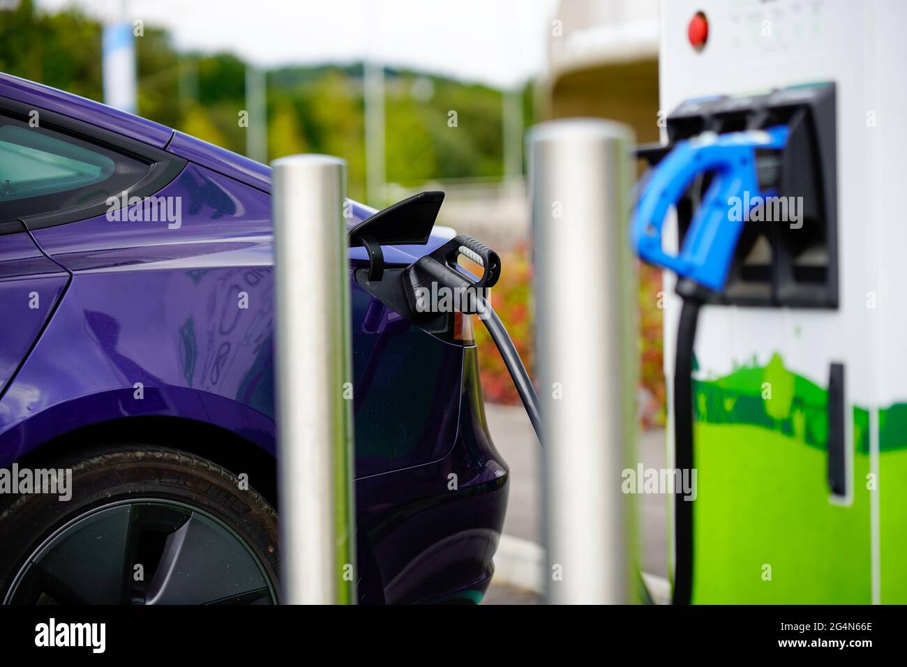selective focus modern car charging up at public electricity charging ...