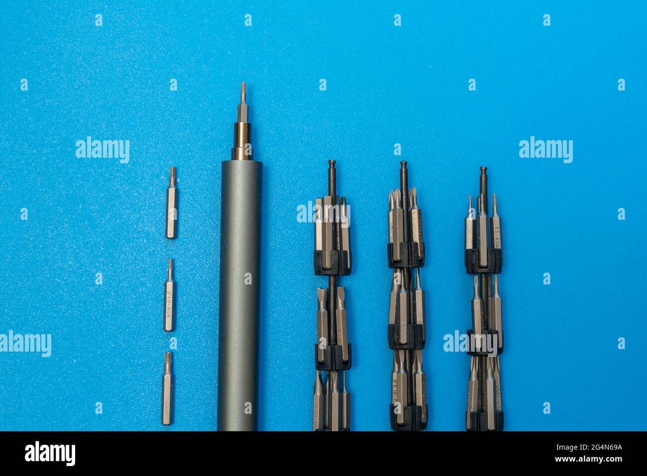 set of the screwdriver and bits on the table. simple abstract flat lay ...