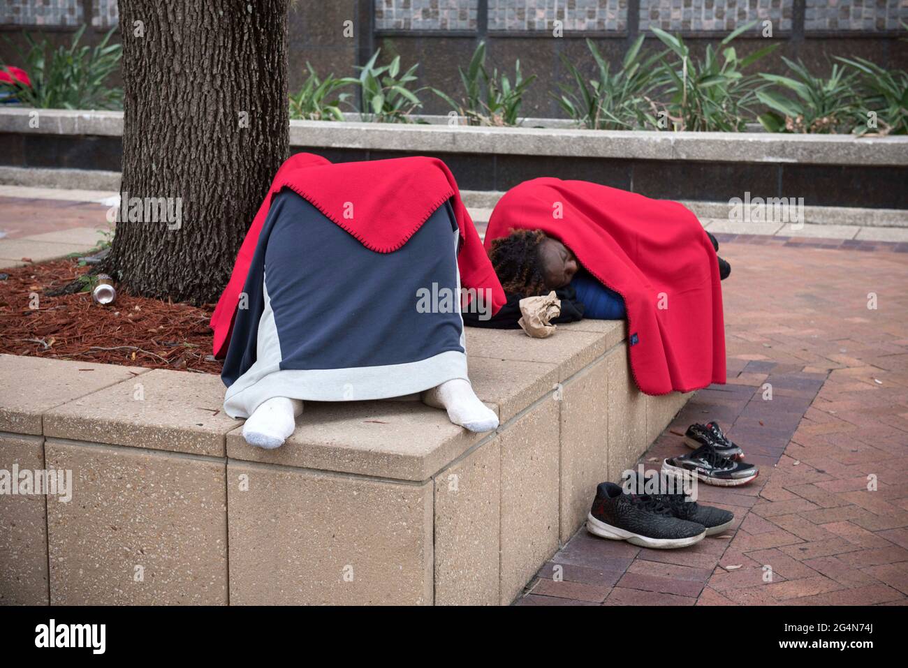 Tampa, FL, USA. 22nd June, 2021. Two homeless women cover themselves ...