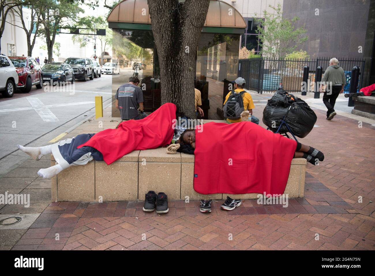 Tampa, FL, USA. 22nd June, 2021. Two homeless women cover themselves ...