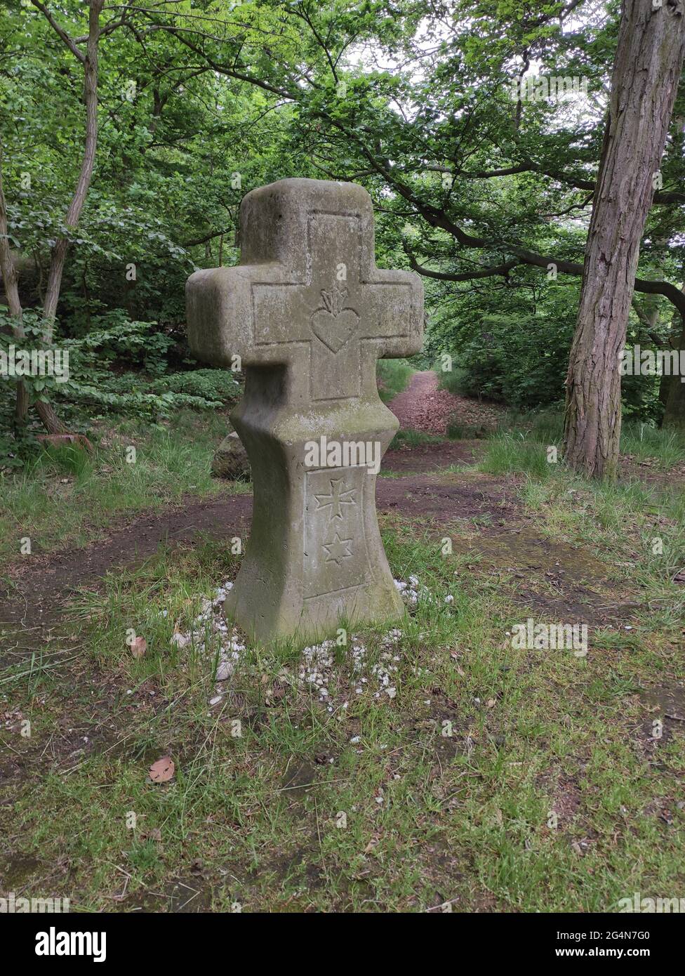Vertical shot of a replica of a destroyed historical cross captured in ...