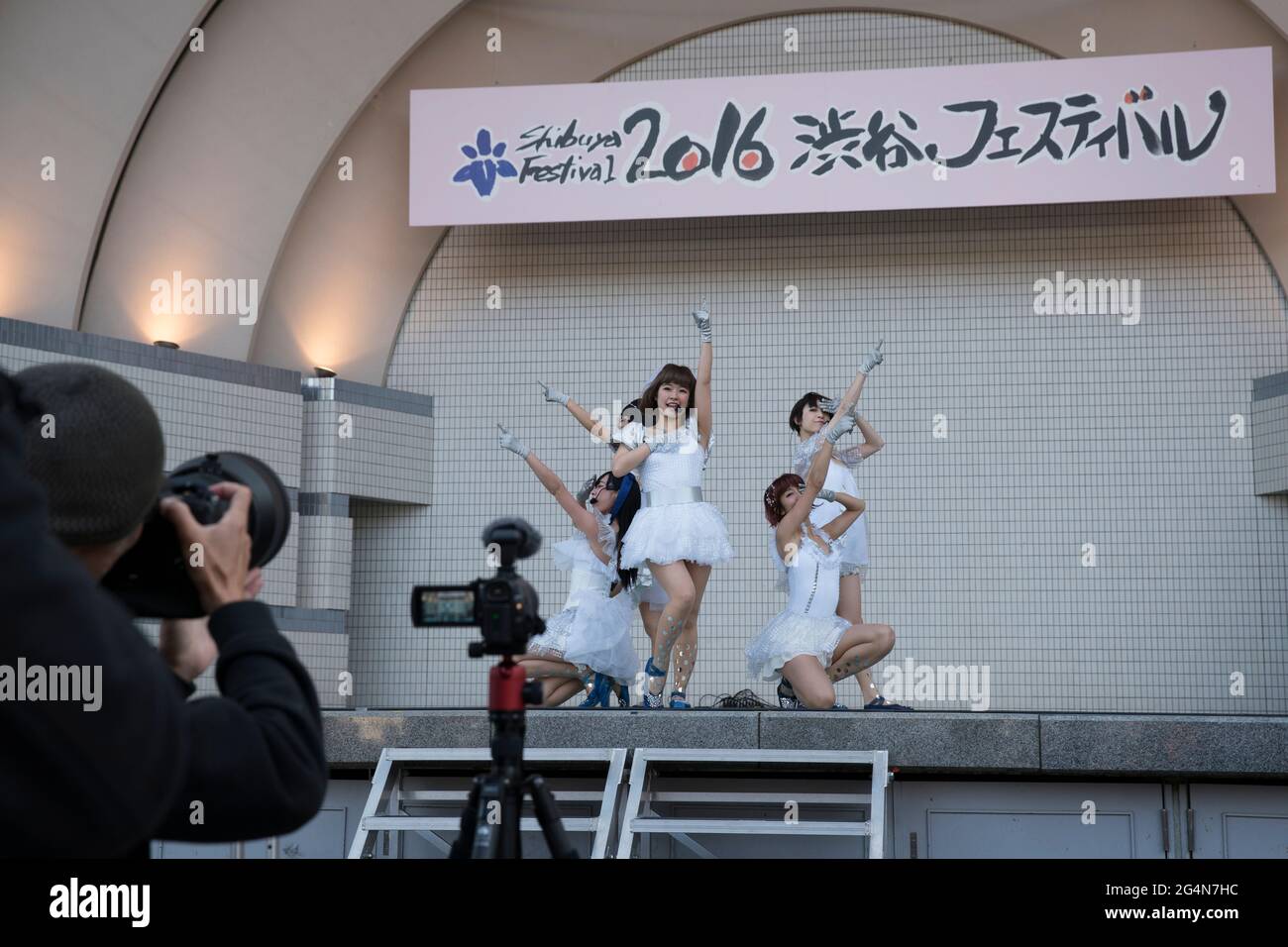 A Japanese girl group performing on stage outdoors in Tokyo, Japan ...