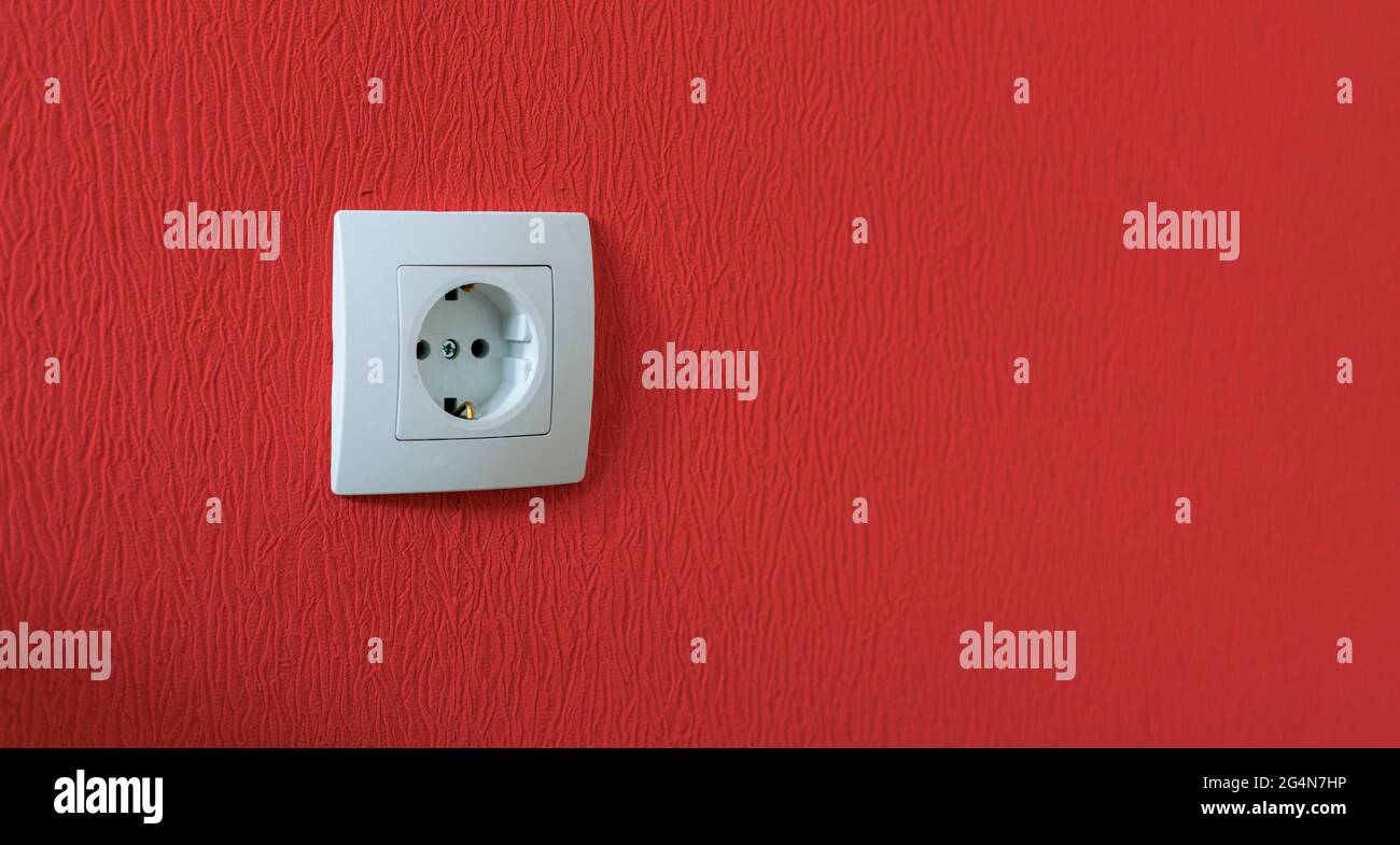 simple single white electricity socket in the wall at home apartment ...