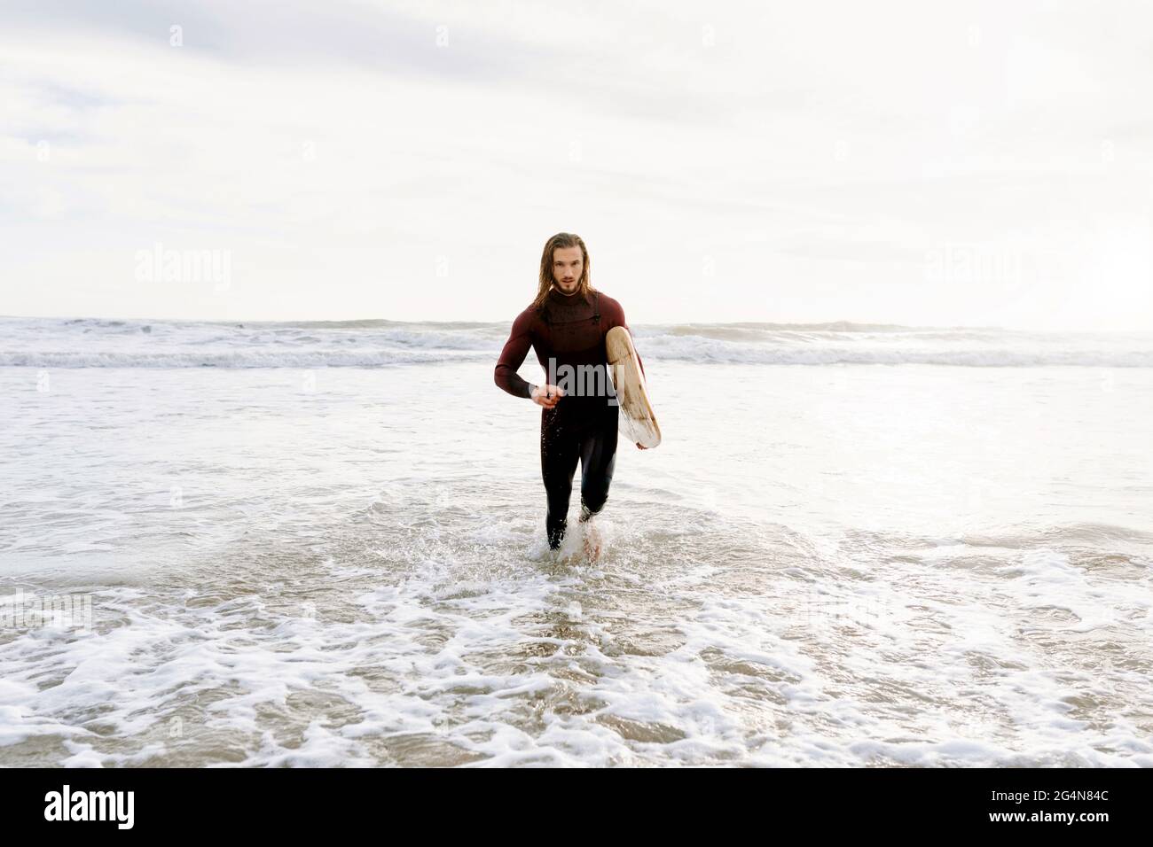 Run into ocean beach wetsuit hi-res stock photography and images - Alamy