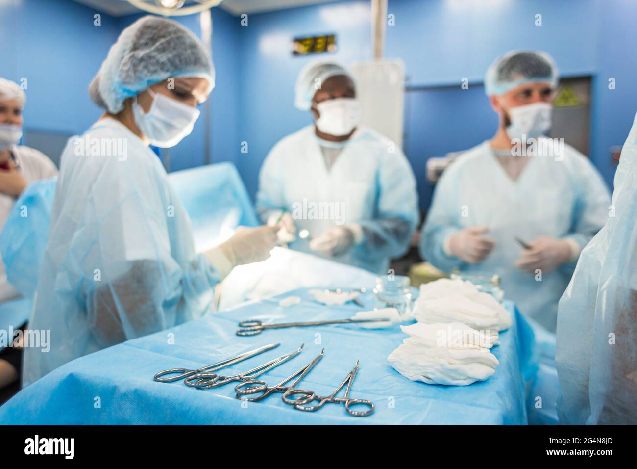 An international team of doctors performs a complex surgical operation ...