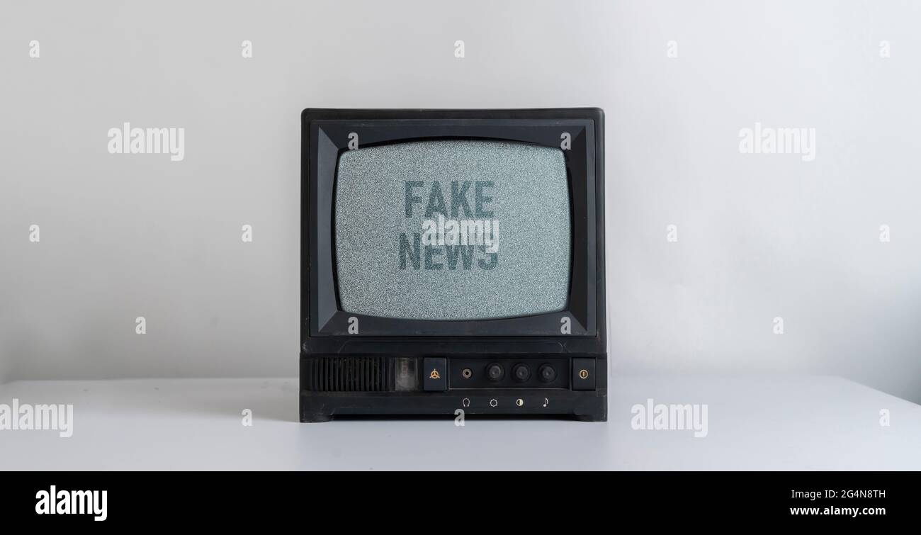 the old vintage tv with gray noise on screen with fake news text ...