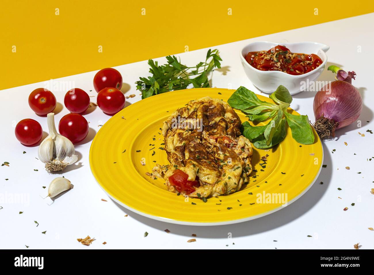 Delicious omelette with chopped parsley on plate against sun dried ...