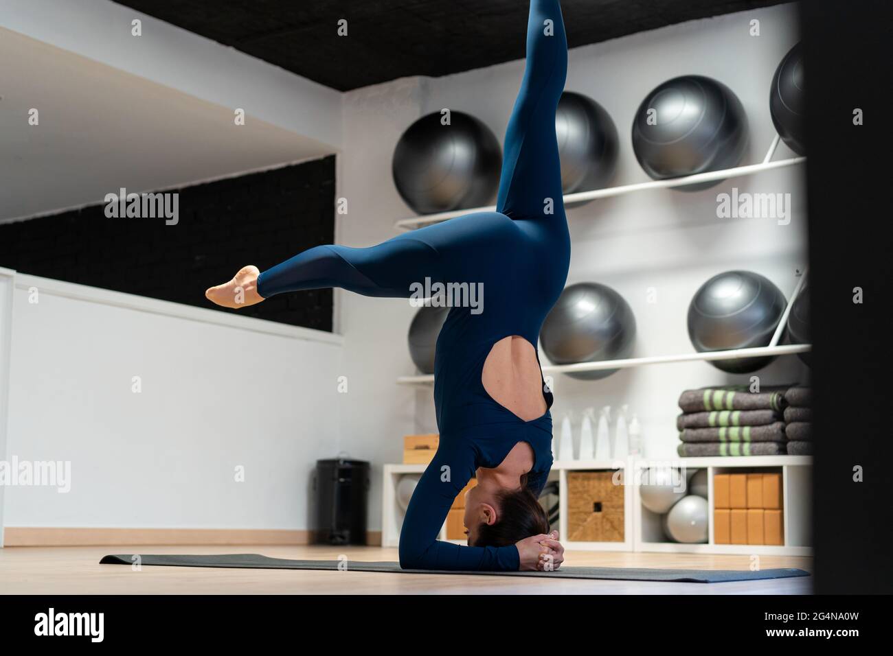 Side headstand pose hi-res stock photography and images - Alamy