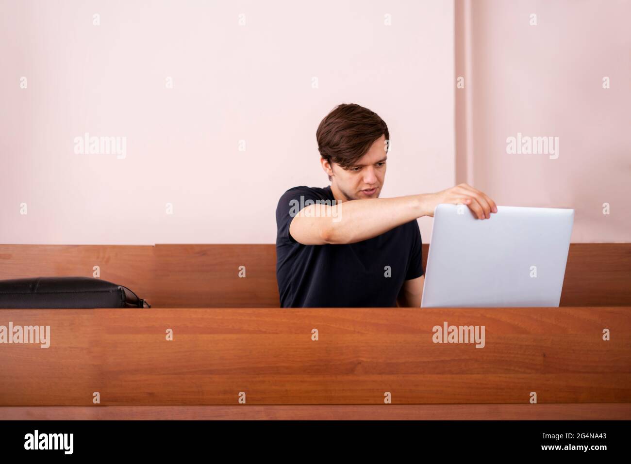 adult student sitting at the table and working laptop, doing homework ...