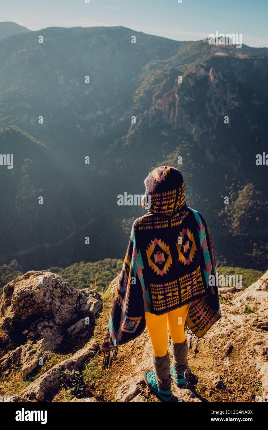 Back view of unrecognizable carefree female explorer standing in ...