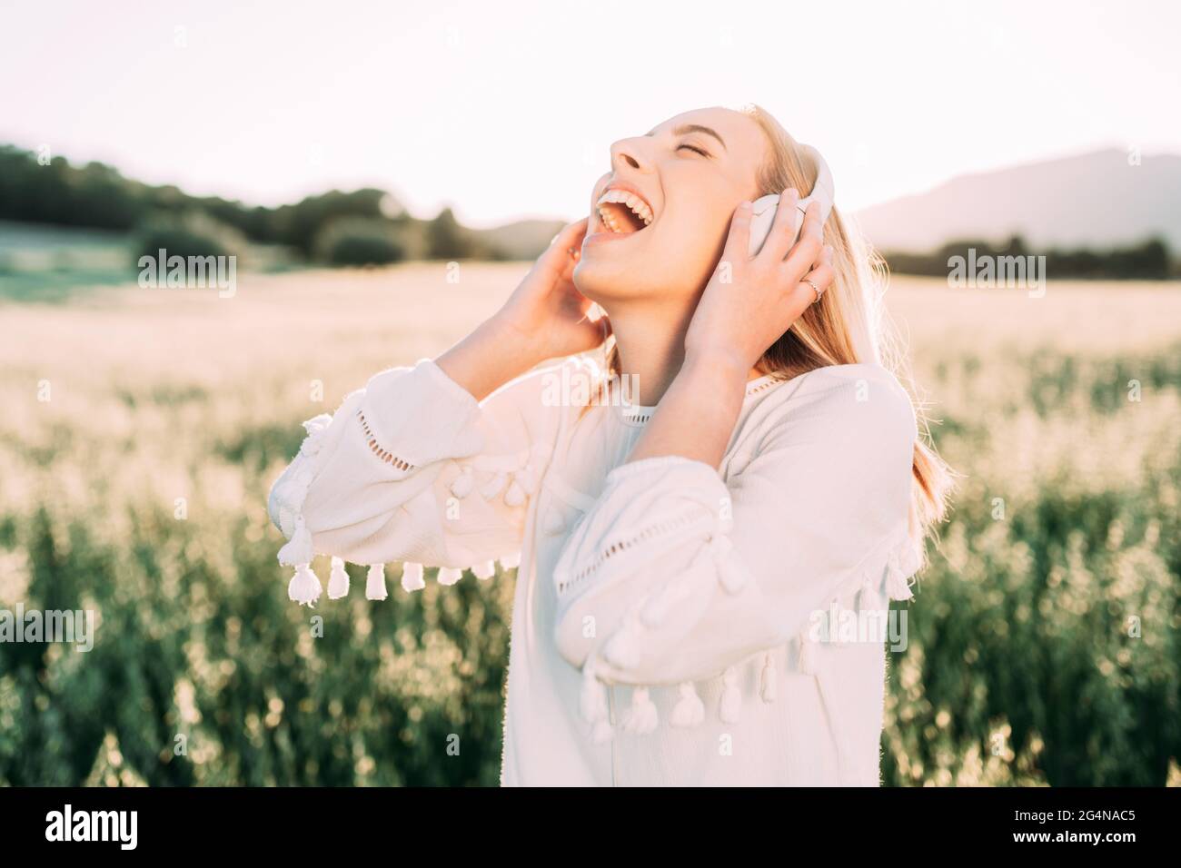 Full body of focused young female in activewear keeping hands in ...
