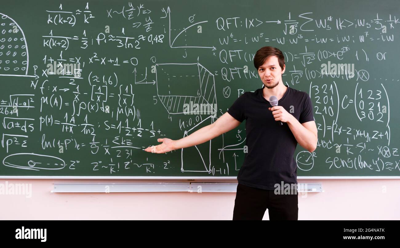teacher of young professor explains the law of physics for students on ...