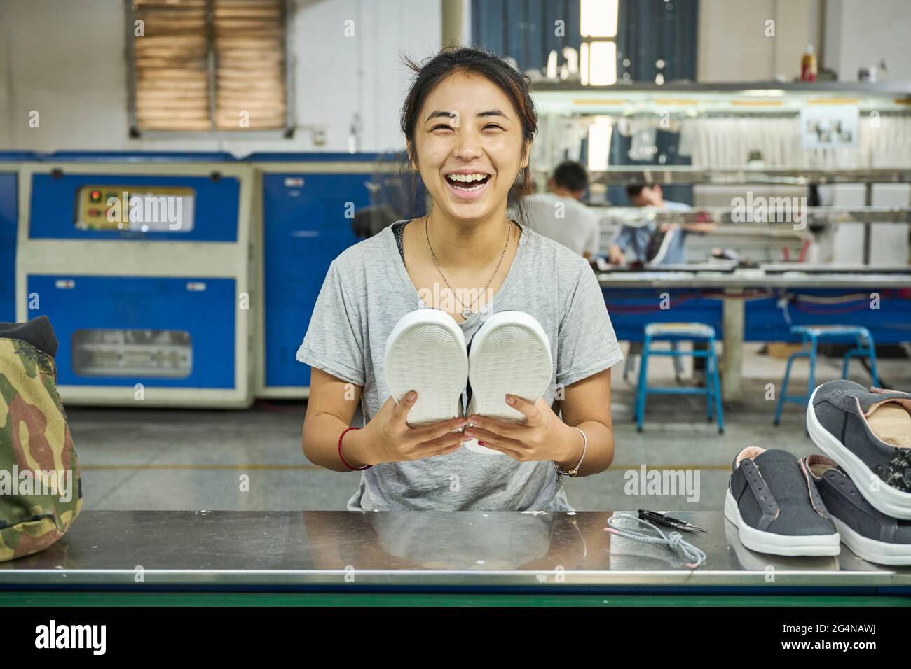 Employee doing quality control in Chinese shoes factory Stock Photo - Alamy