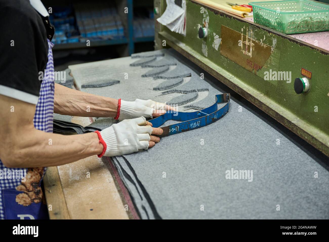 Detail of worker using of cutting pattern while cutting fabric in ...