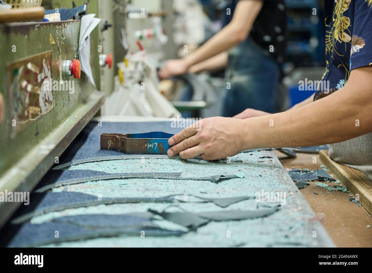 Detail of worker using of cutting pattern while cutting fabric in ...