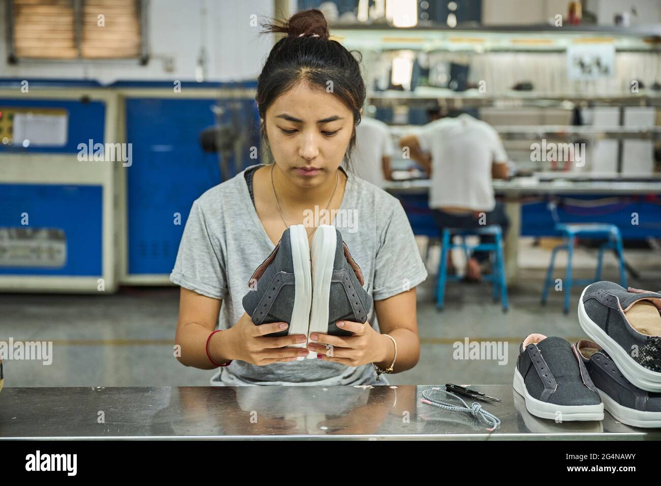 Employee doing quality control in Chinese shoes factory Stock Photo - Alamy