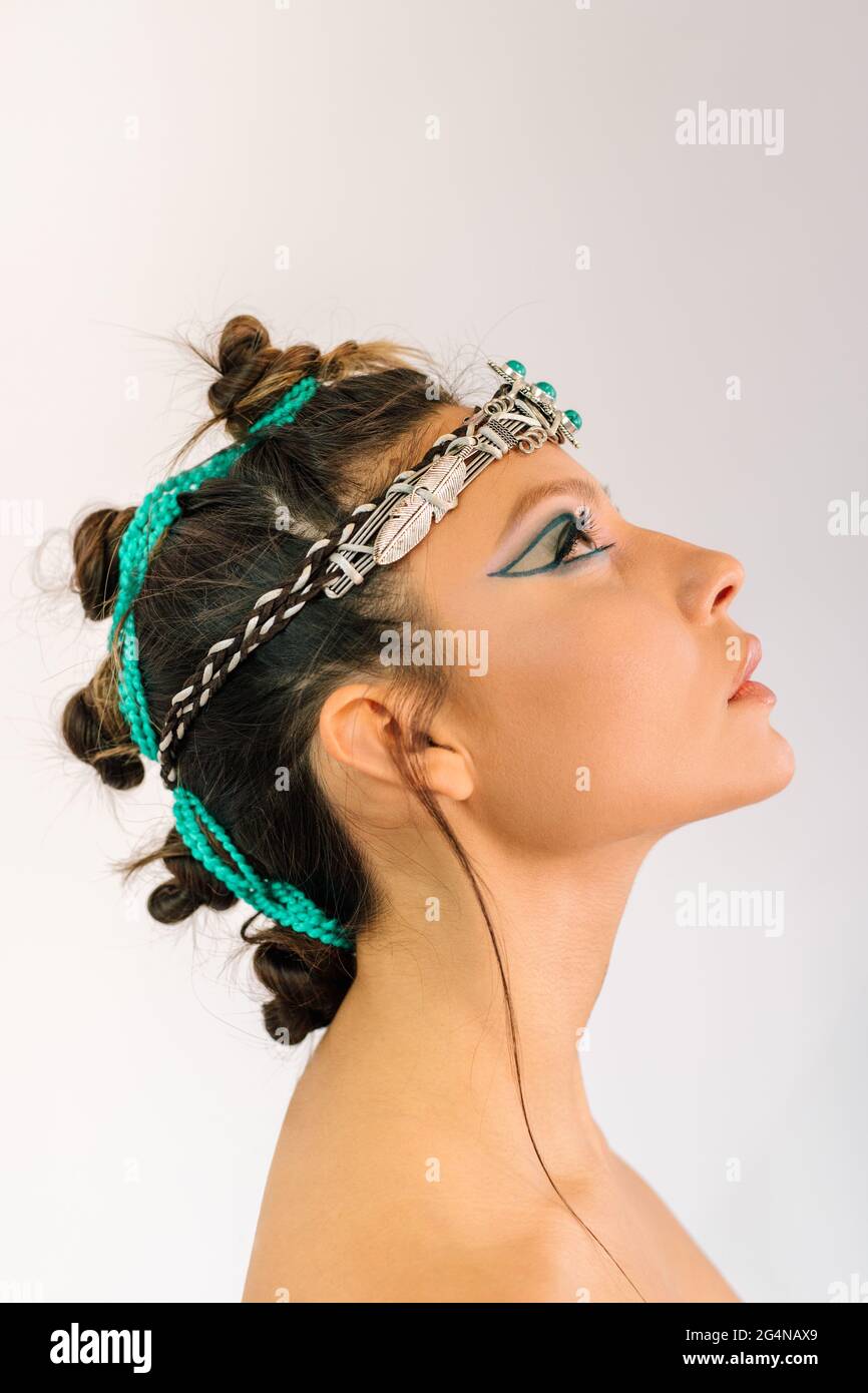 Side view of beautiful young female model with oriental style makeup ...