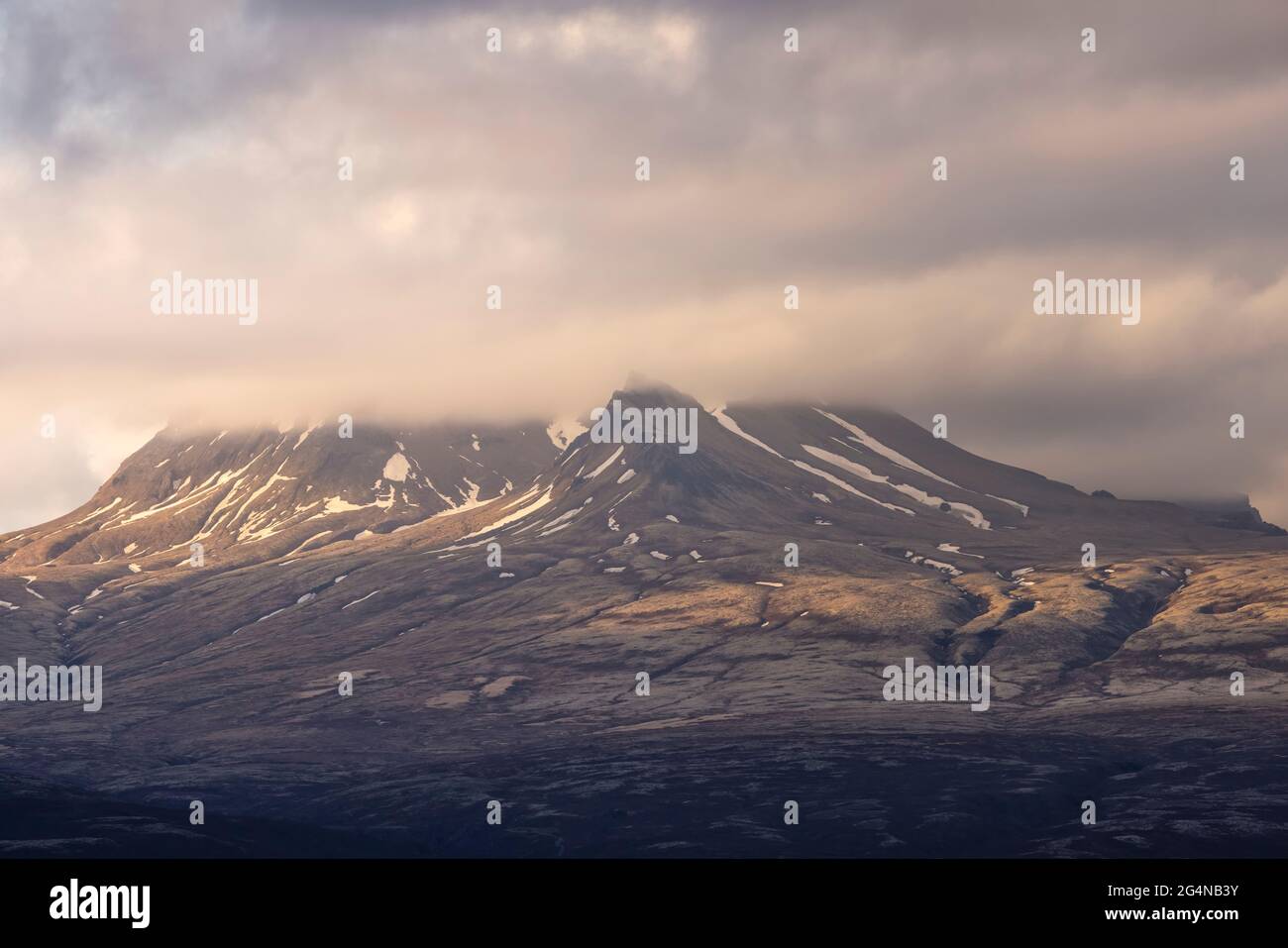 Thick clouds floating on morning sky over mountain ridge covered with ...