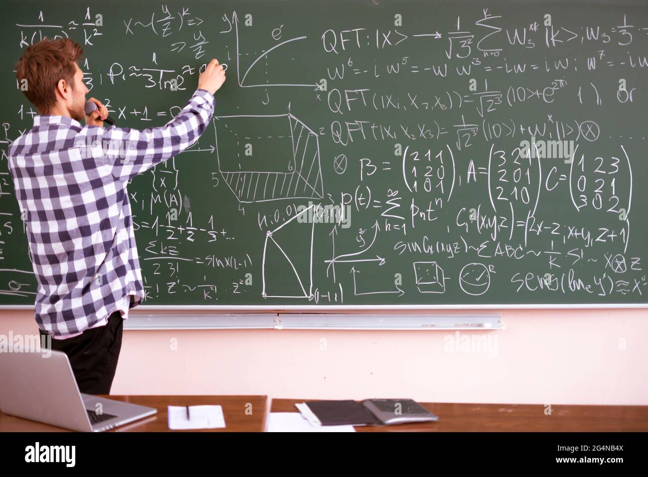 teacher of young professor explains the law of physics for students on ...