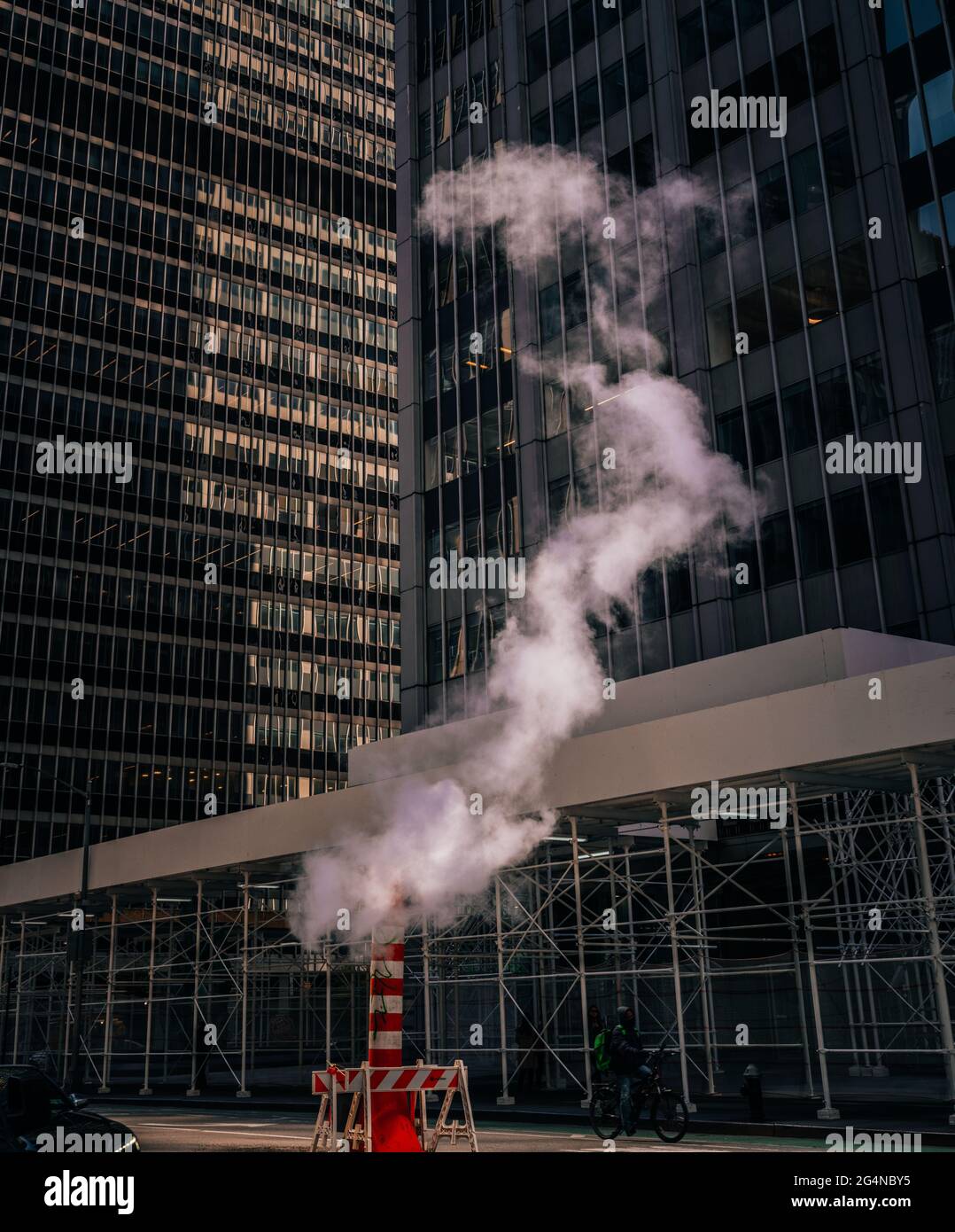 Vertical shot of smoke coming out a pipe on the street of New York City ...