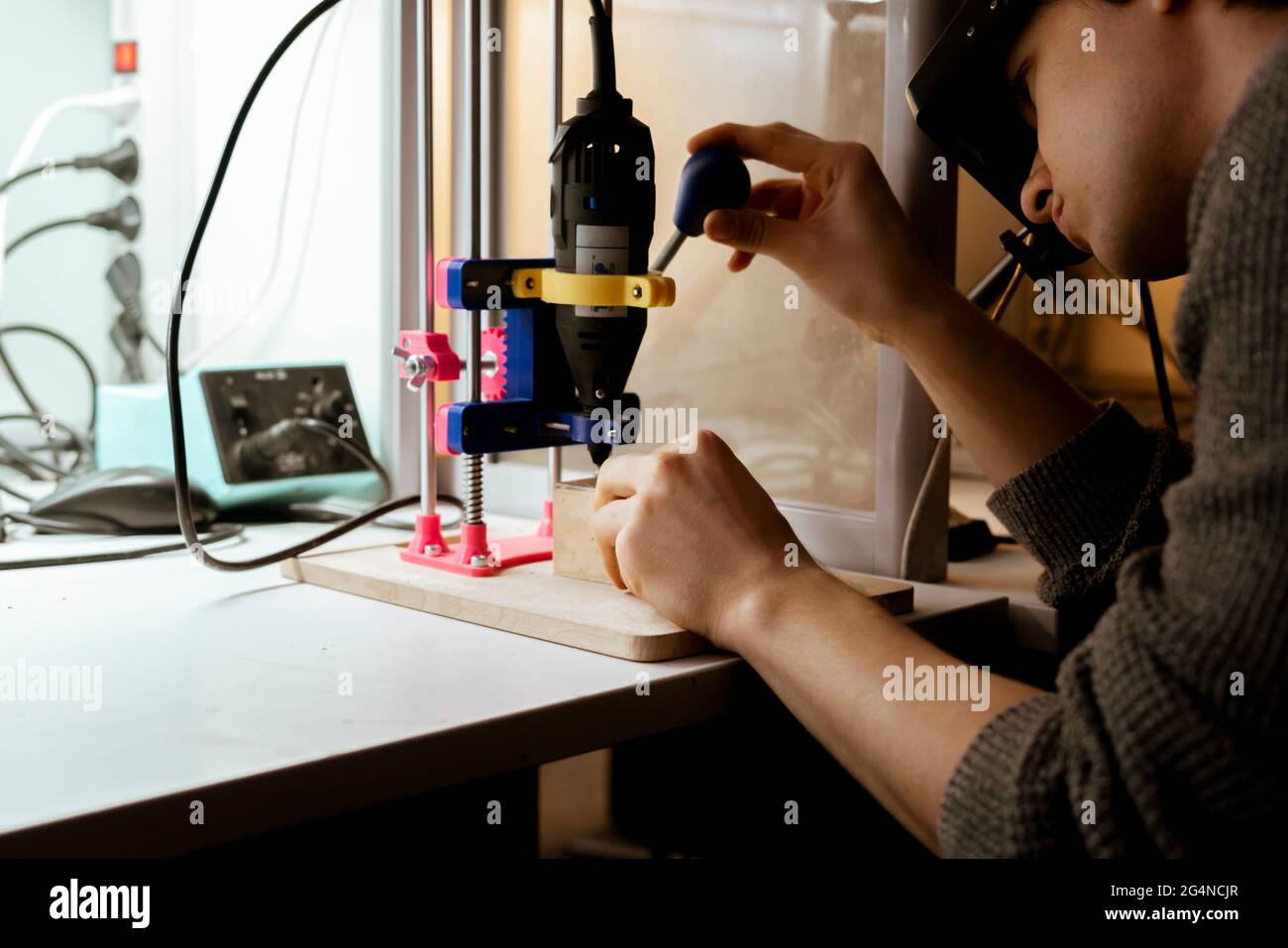 close up male engineer working in the laboratory, drilling the electric ...