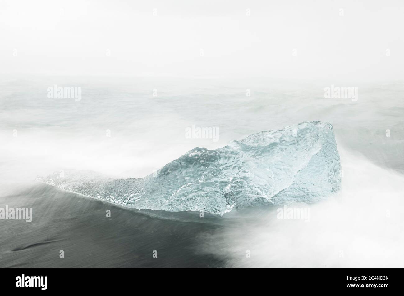 Ice block lying on beach Stock Photo - Alamy