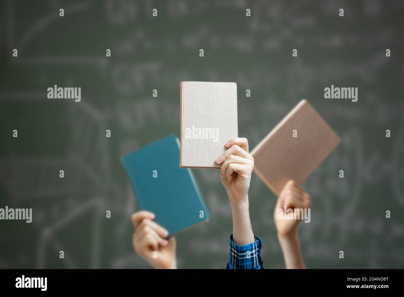 group of raised people hands holding books isolated against the ...