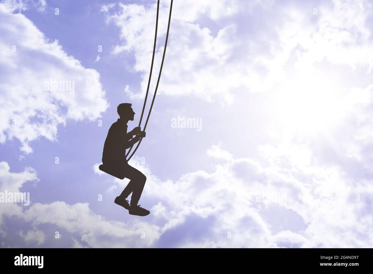 flying high in the sky with clouds, man on a swing, relax and dream in ...