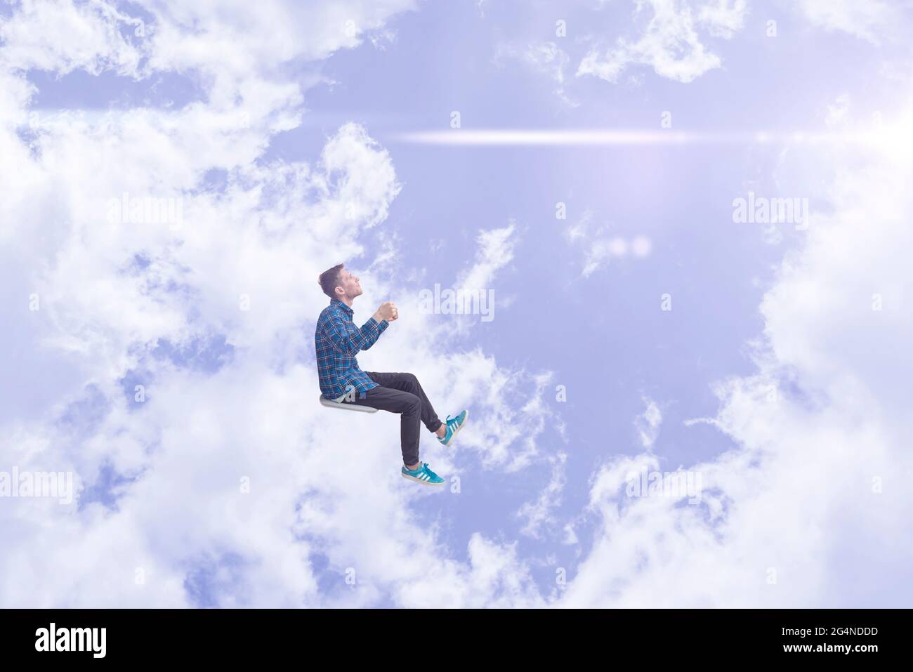 flying high in the sky with clouds, man on a swing, relax and dream in ...