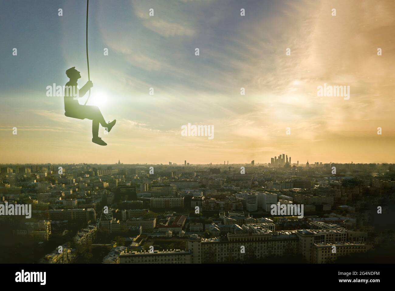 flying high in the sky with clouds, man on a swing, relax and dream in ...