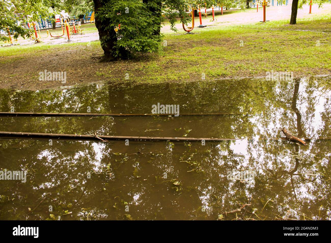 Public park drenched in rain. Water logged park.Wet benches. Park ...